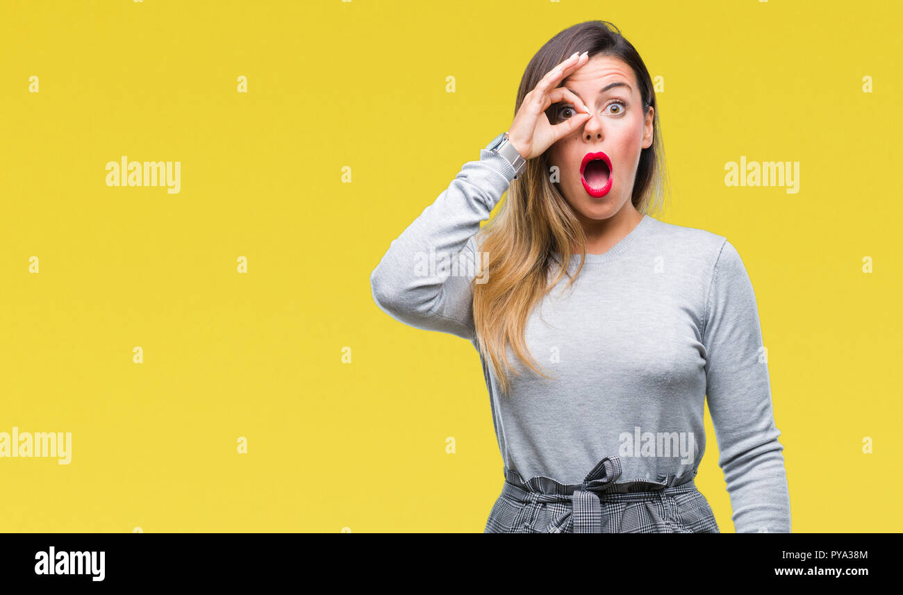 Young beautiful worker business woman over isolated background doing ok ...