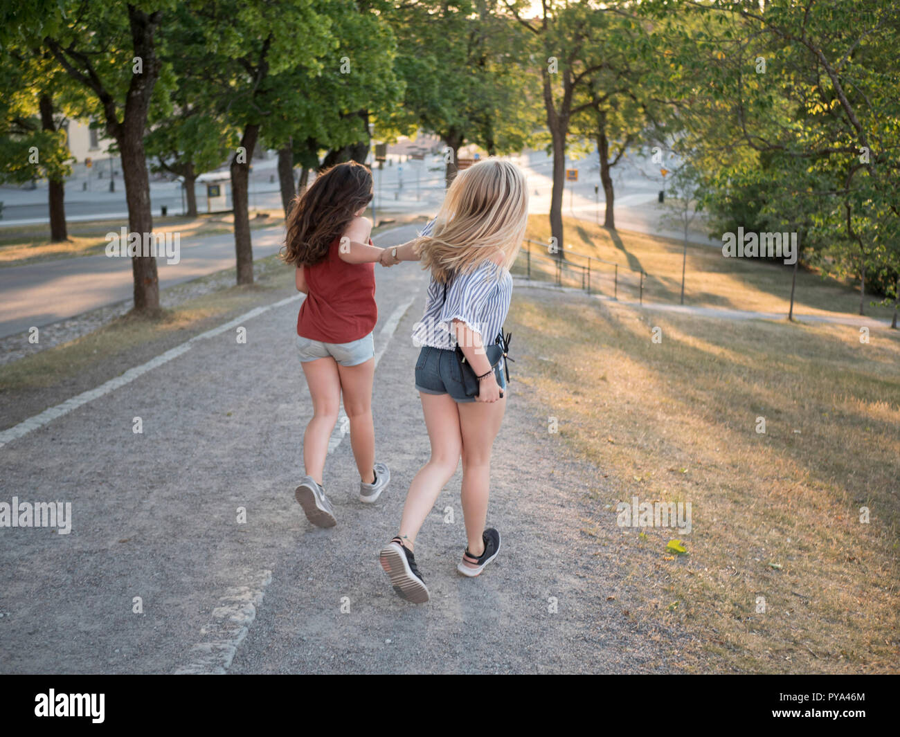 two sisters talk while walking Stock Photo - Alamy