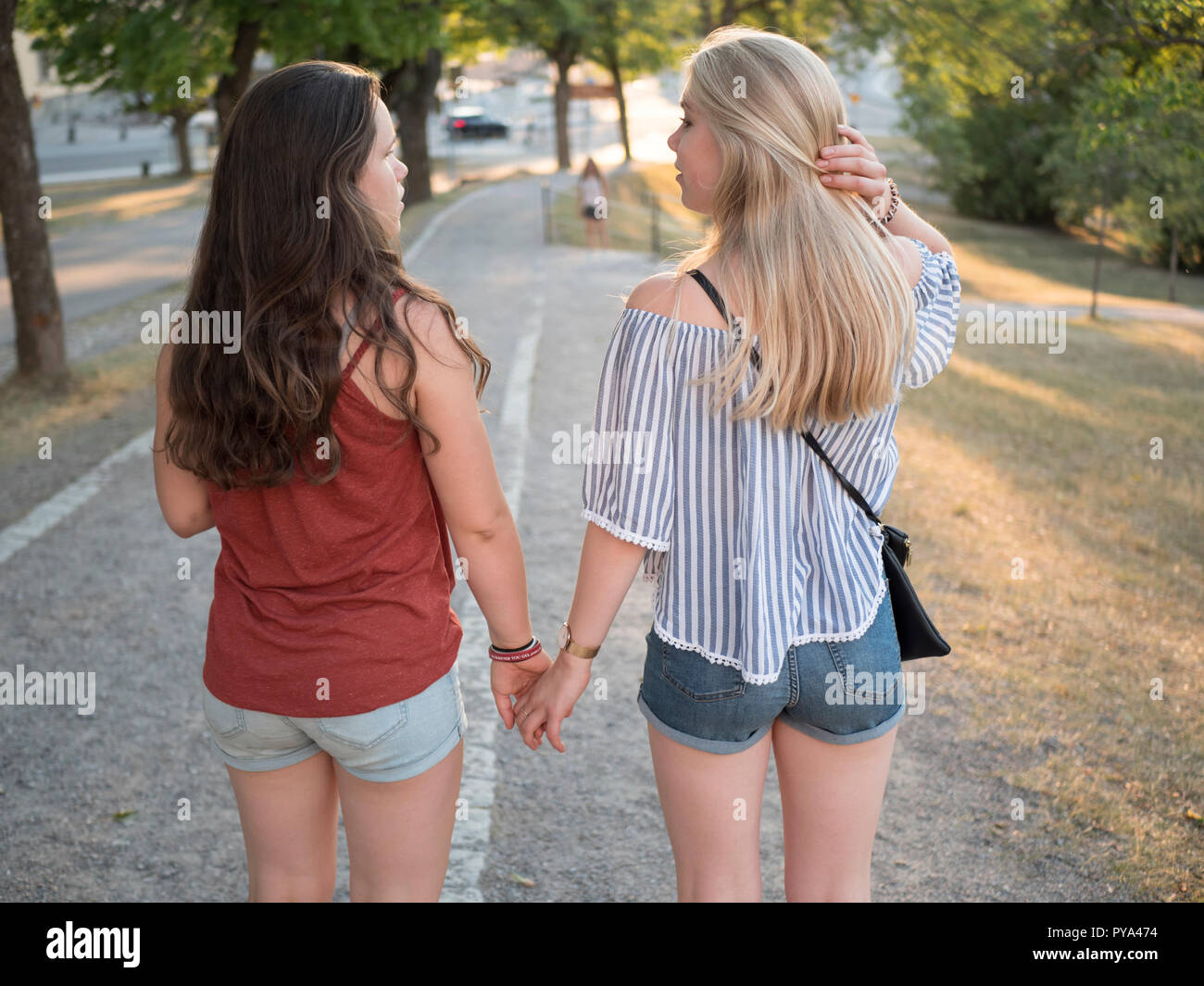 two sisters talk while walking Stock Photo - Alamy