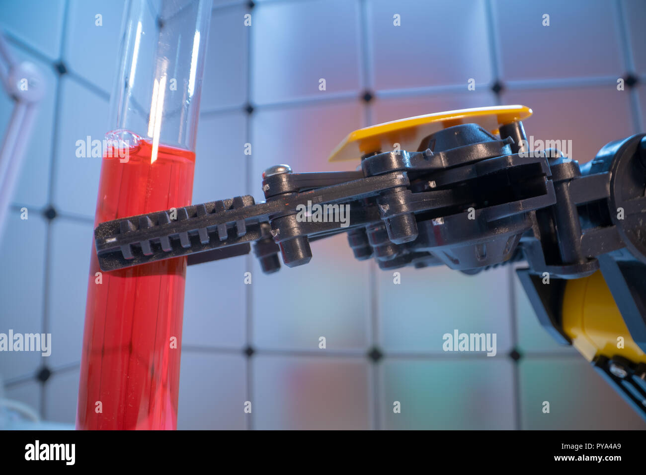 Test tube in robot arm. robot manipulates chemical tubes in the ...