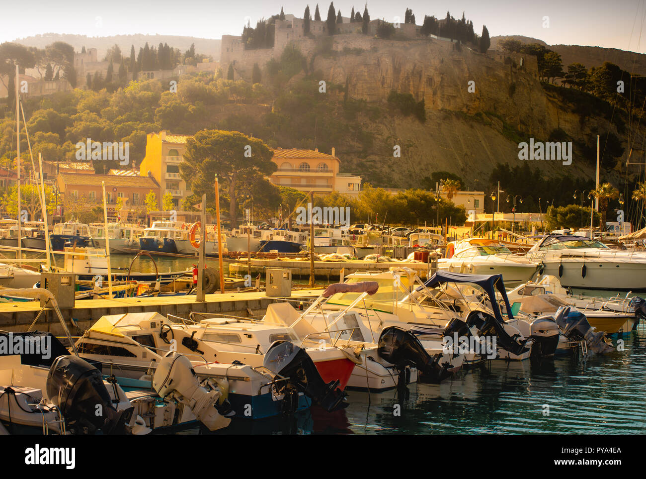 Chateau de Cassis castle on top of hill and close up of boats moored in ...