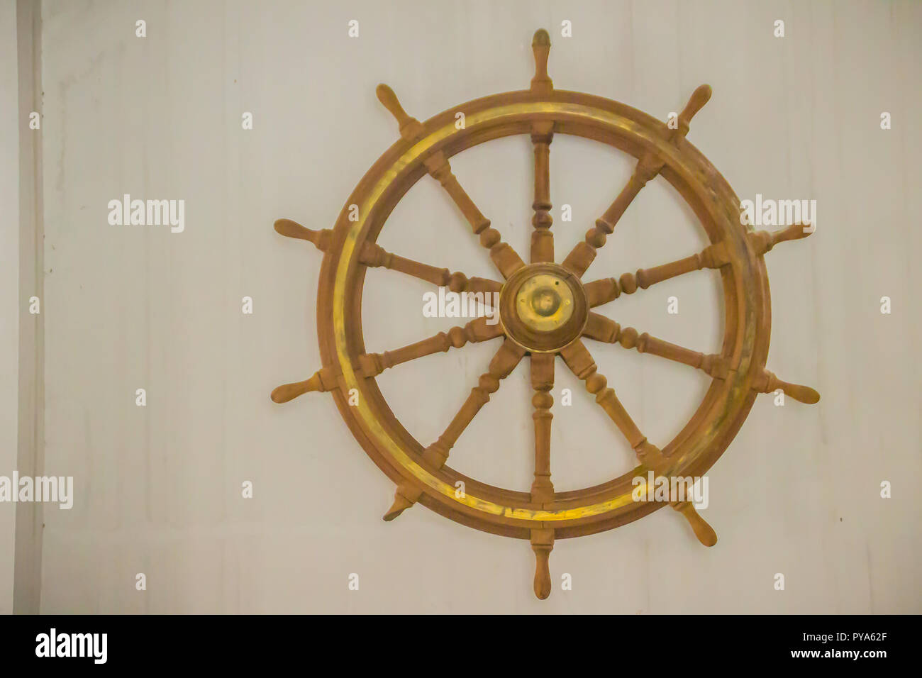 Vintage old wooden ship steering wheel in the public naval museum ...