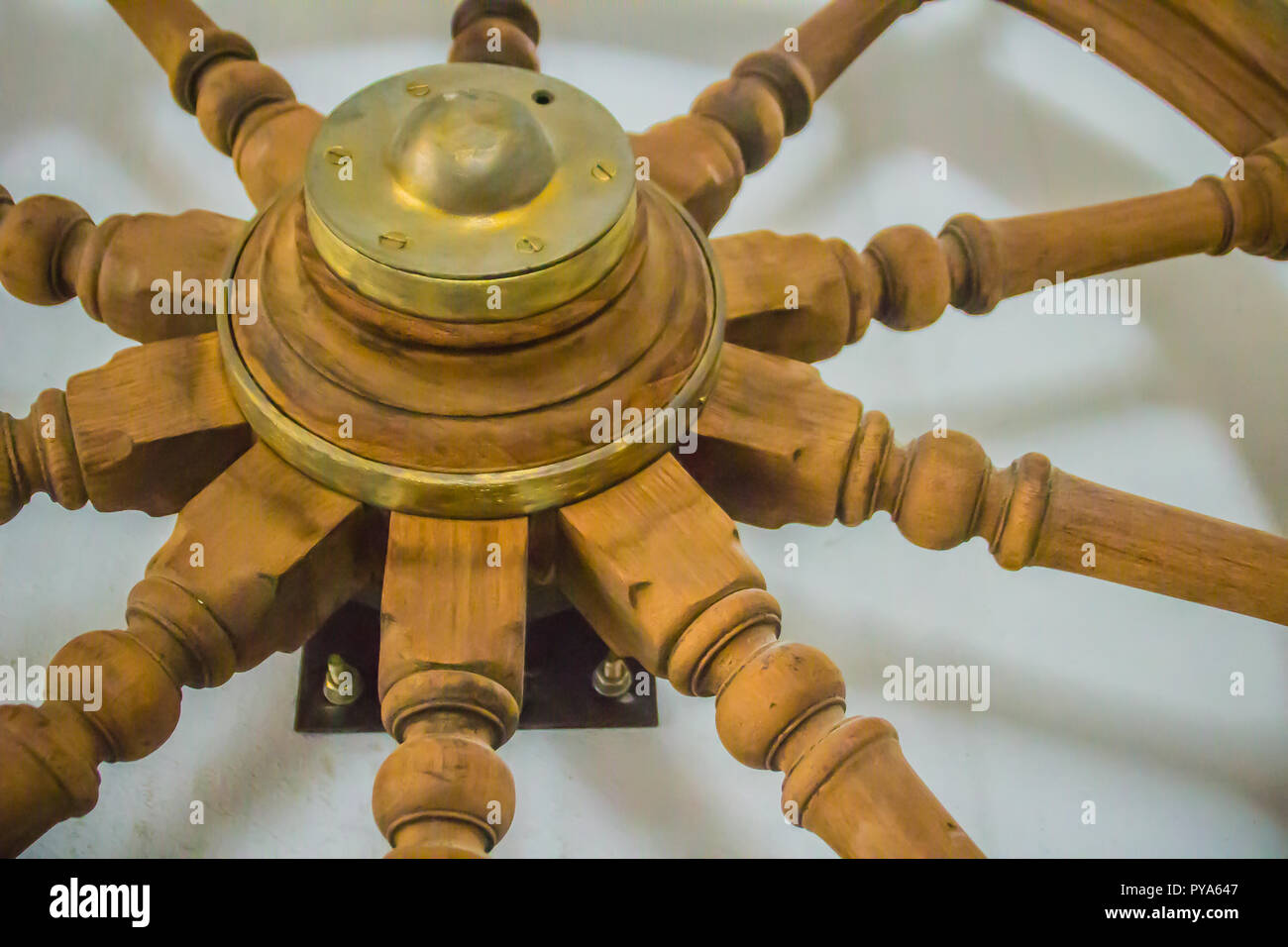 Vintage old wooden ship steering wheel in the public naval museum ...