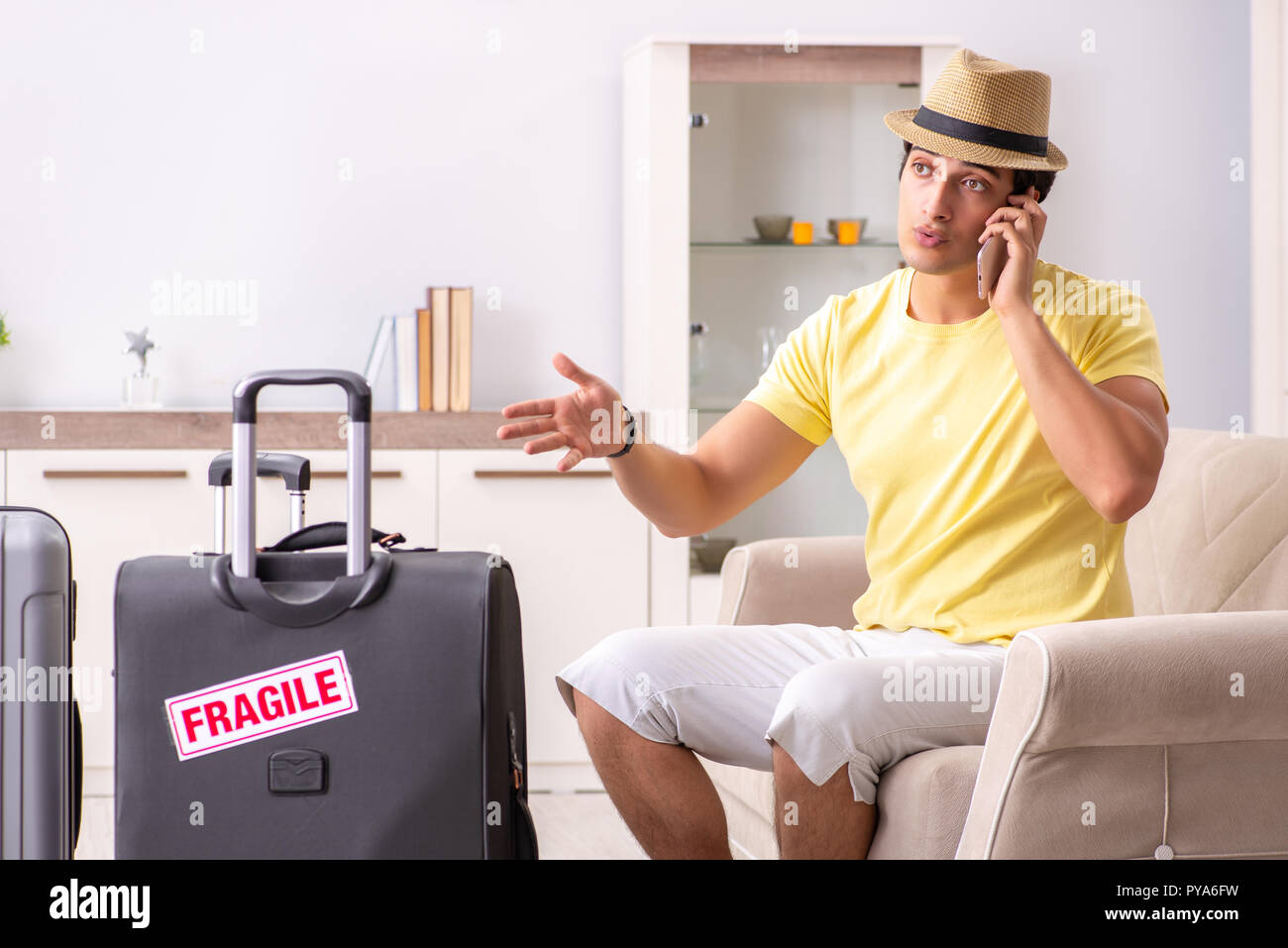 Man going on vacation with fragile suitcases Stock Photo - Alamy