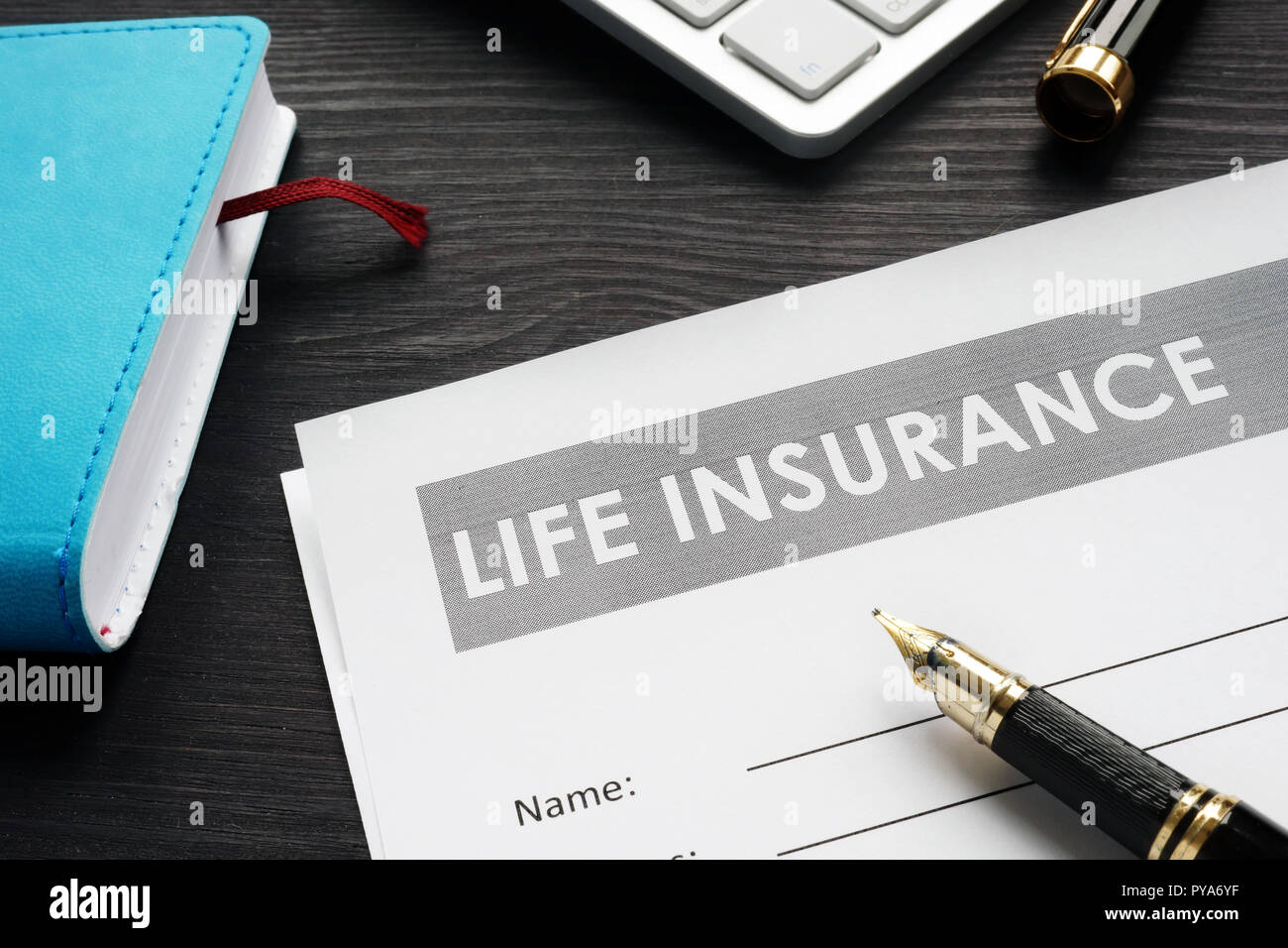 Life insurance policy and pen on a desk Stock Photo - Alamy