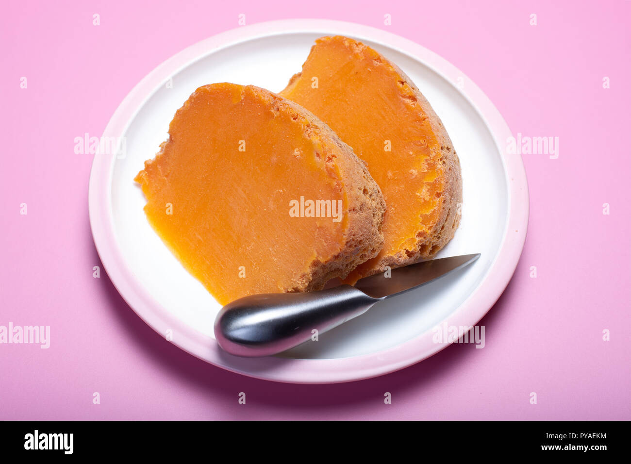 Two pieces of native French aged cheese Mimolette, produced in Lille ...