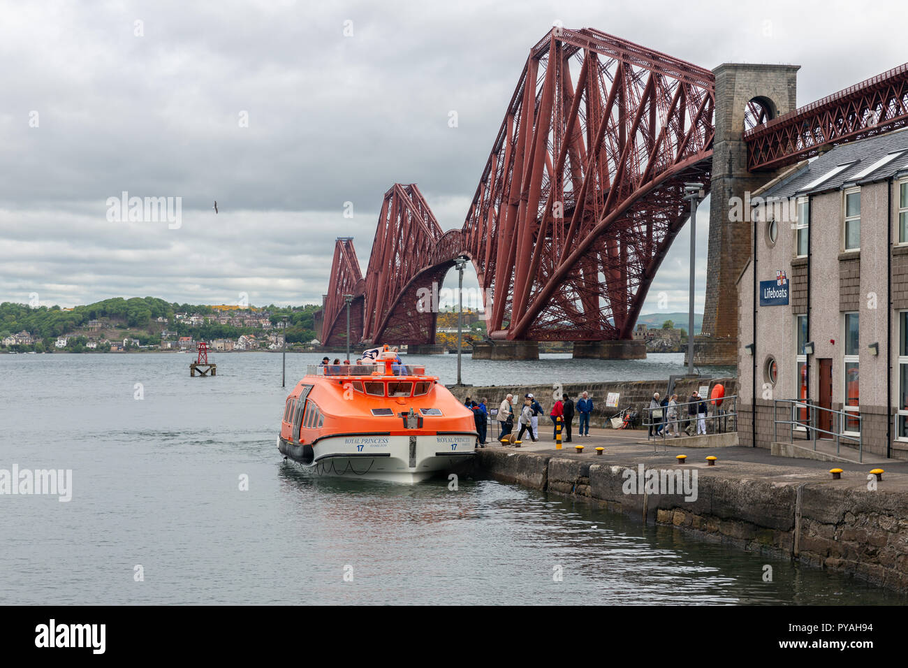 Forth Bridge in Scotland with tender cruise ship debarking passengers ...
