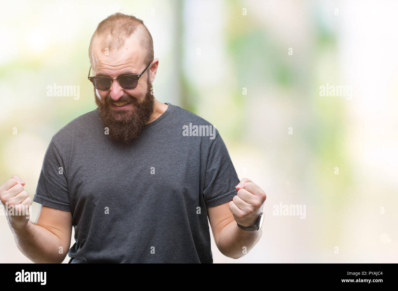Young caucasian hipster man wearing sunglasses over isolated background ...