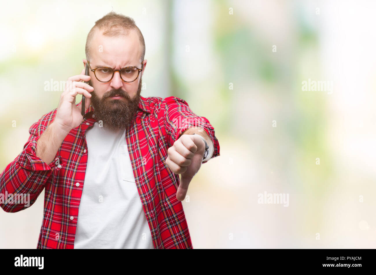 Young caucasian hipster man talking on smartphone over isolated ...