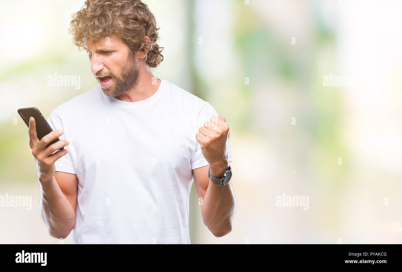 Handsome hispanic man model sending message texting using smartphone ...