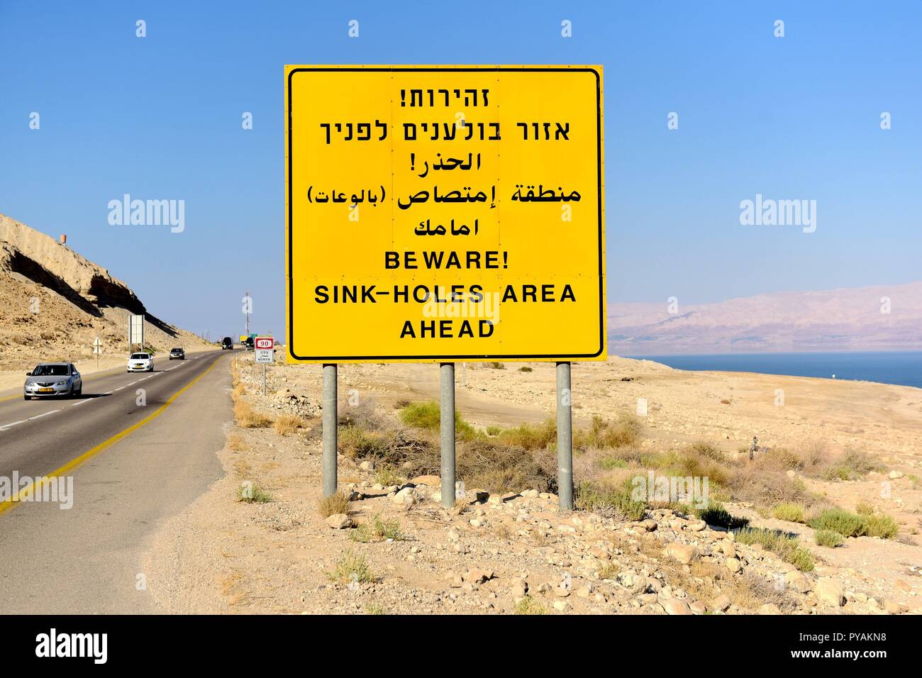 A traffic sign with a warning of sink holes near the shore of the Dead ...