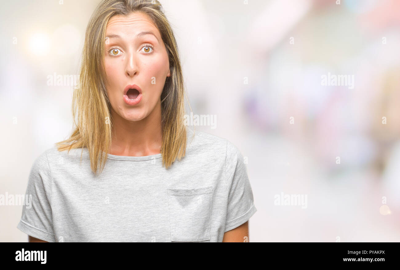 Young beautiful woman over isolated background afraid and shocked with ...