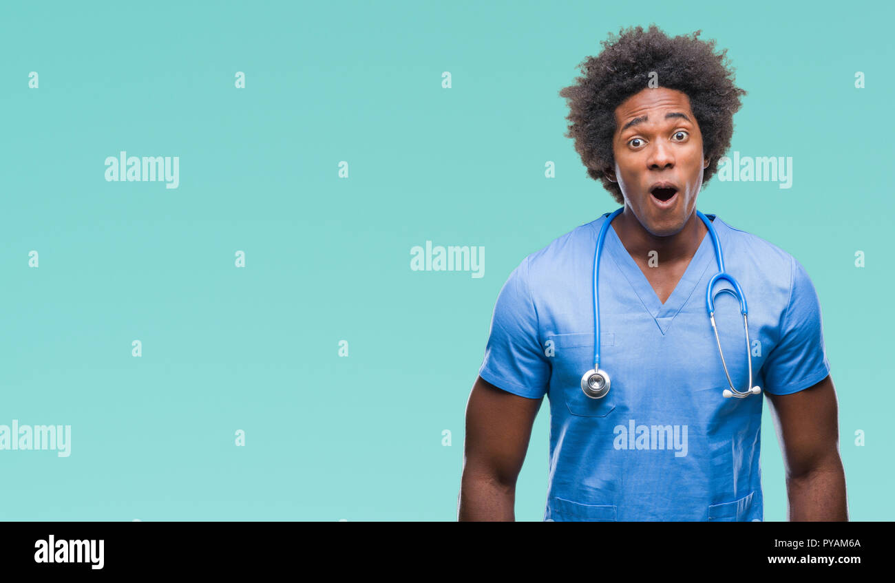 Afro american surgeon doctor man over isolated background afraid and ...