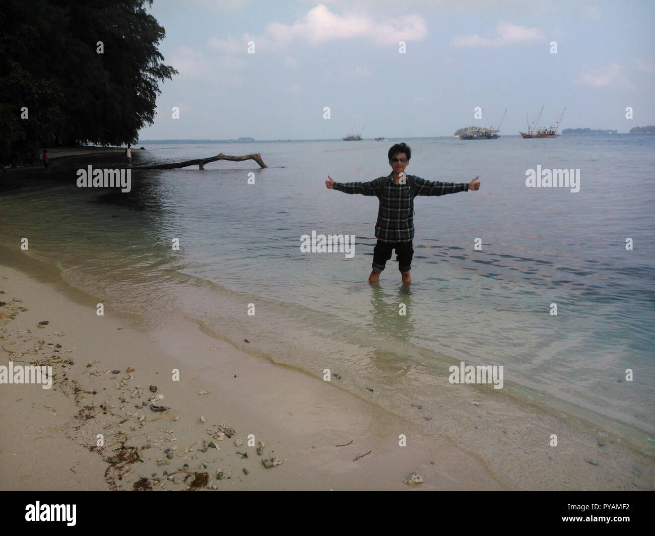 a man relaxing in beautiful beach Stock Photo - Alamy