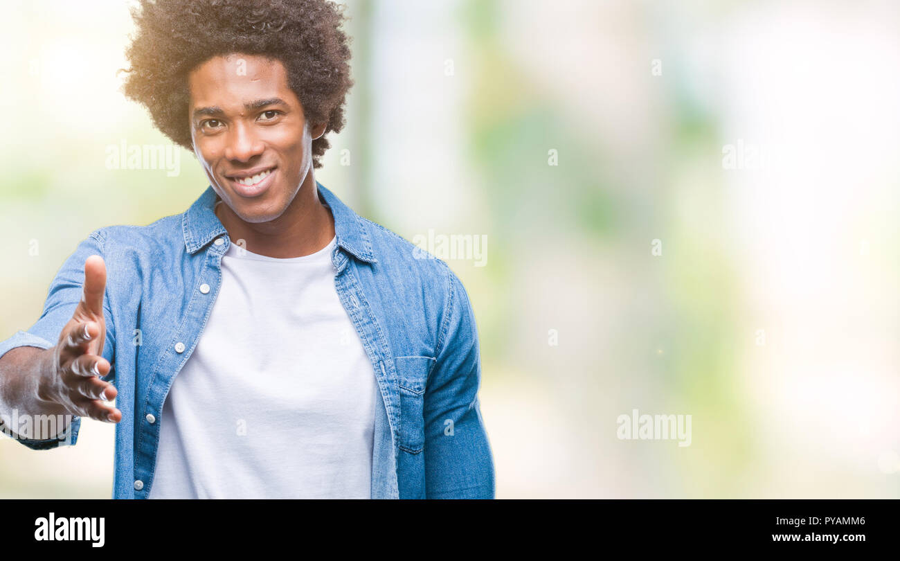 Afro american man over isolated background smiling friendly offering ...