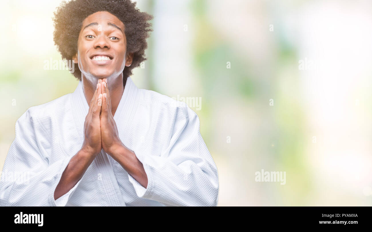 Afro american man wearing karate kimono over isolated background ...
