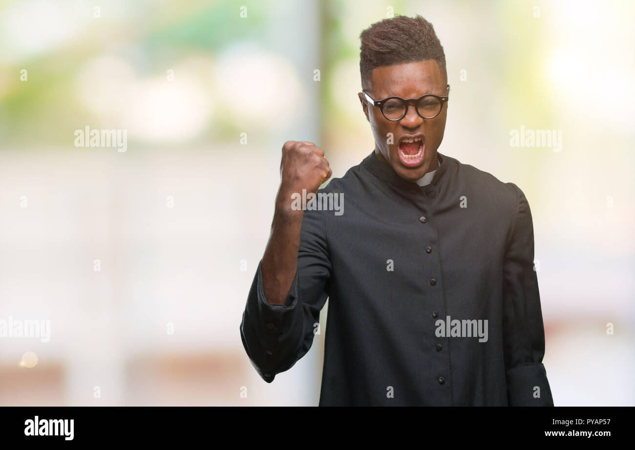 Young african american priest man over isolated background angry and ...