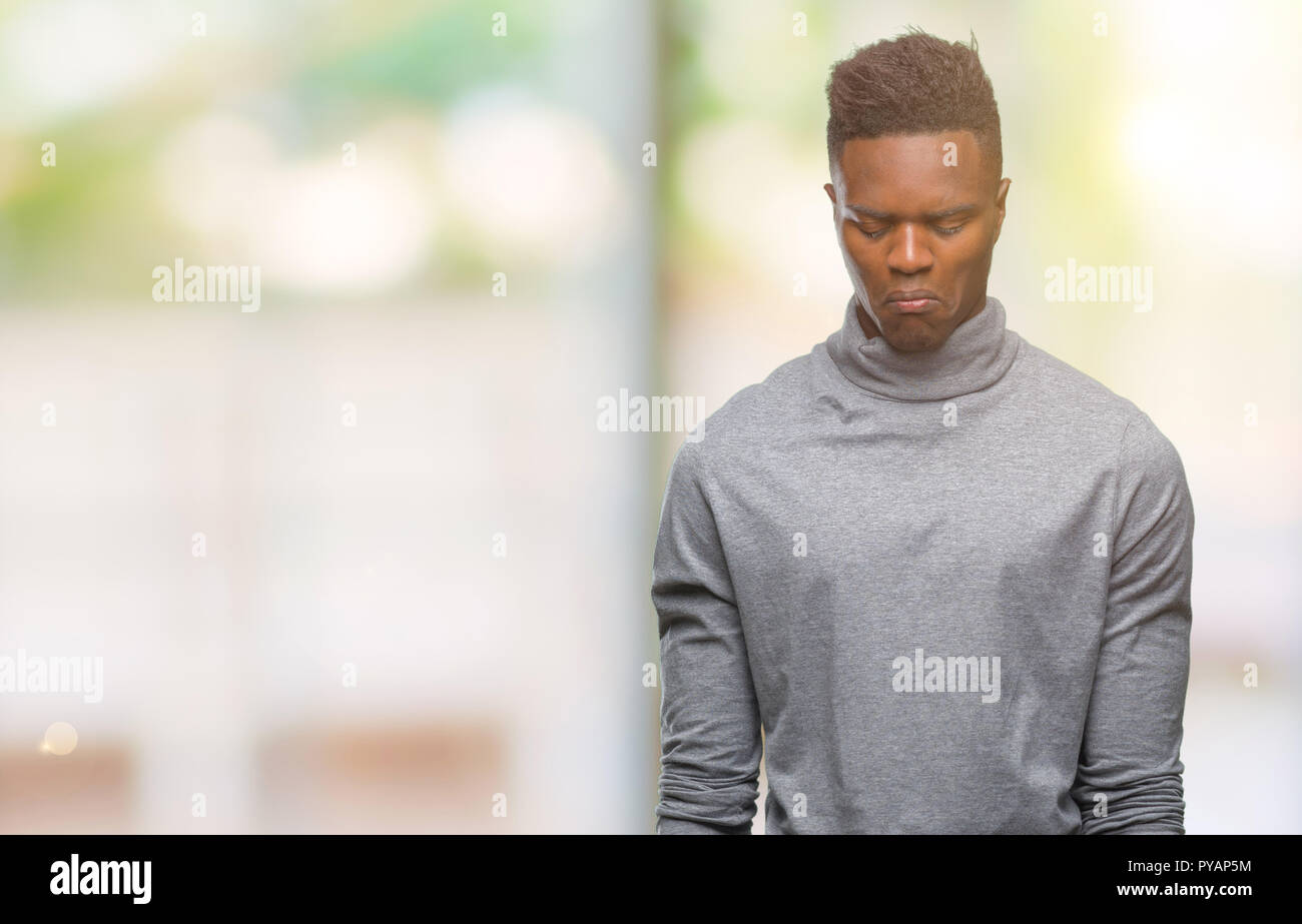 Young african american man over isolated background depressed and worry ...