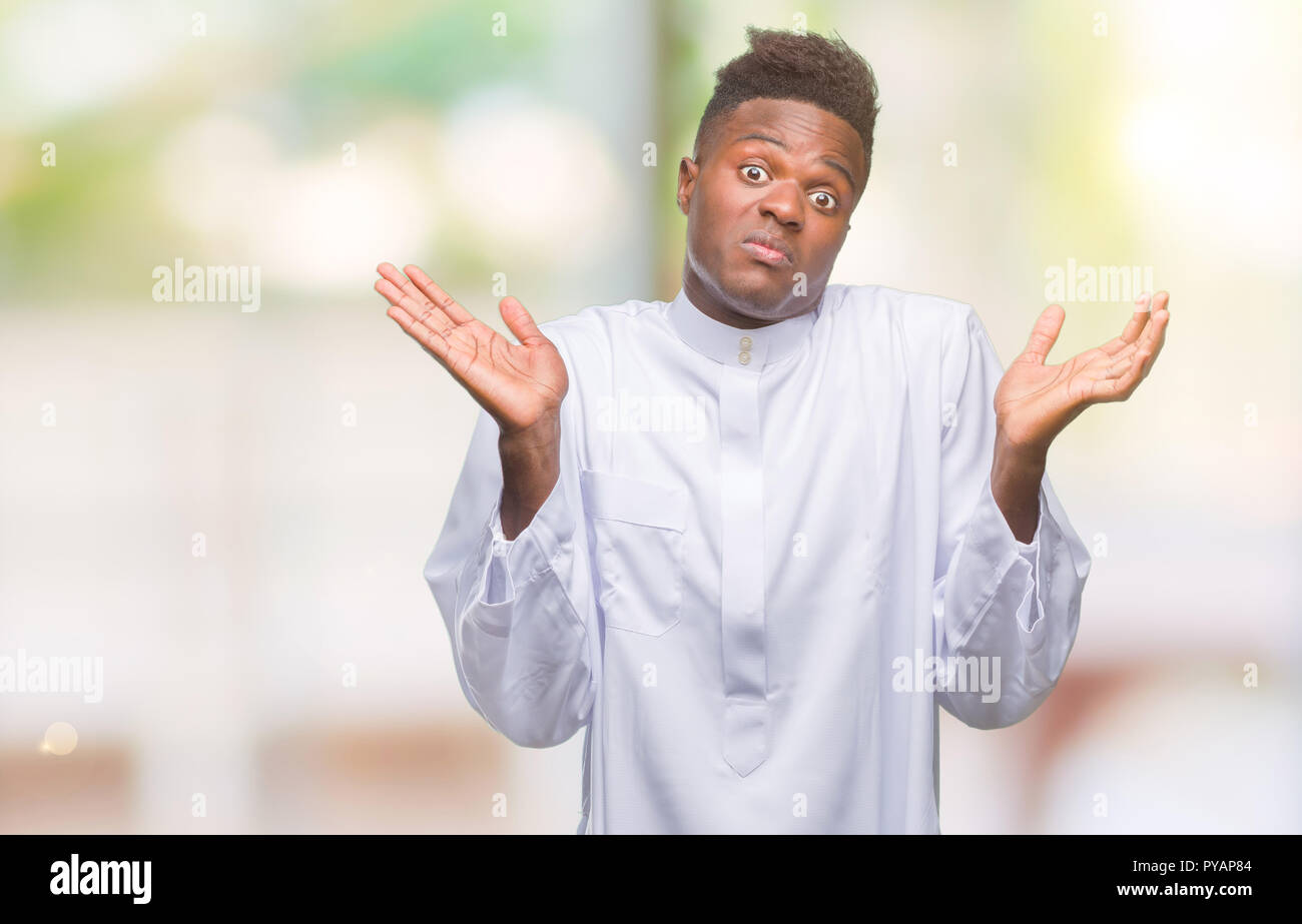 Young arabic african man wearing traditional djellaba over isolated ...