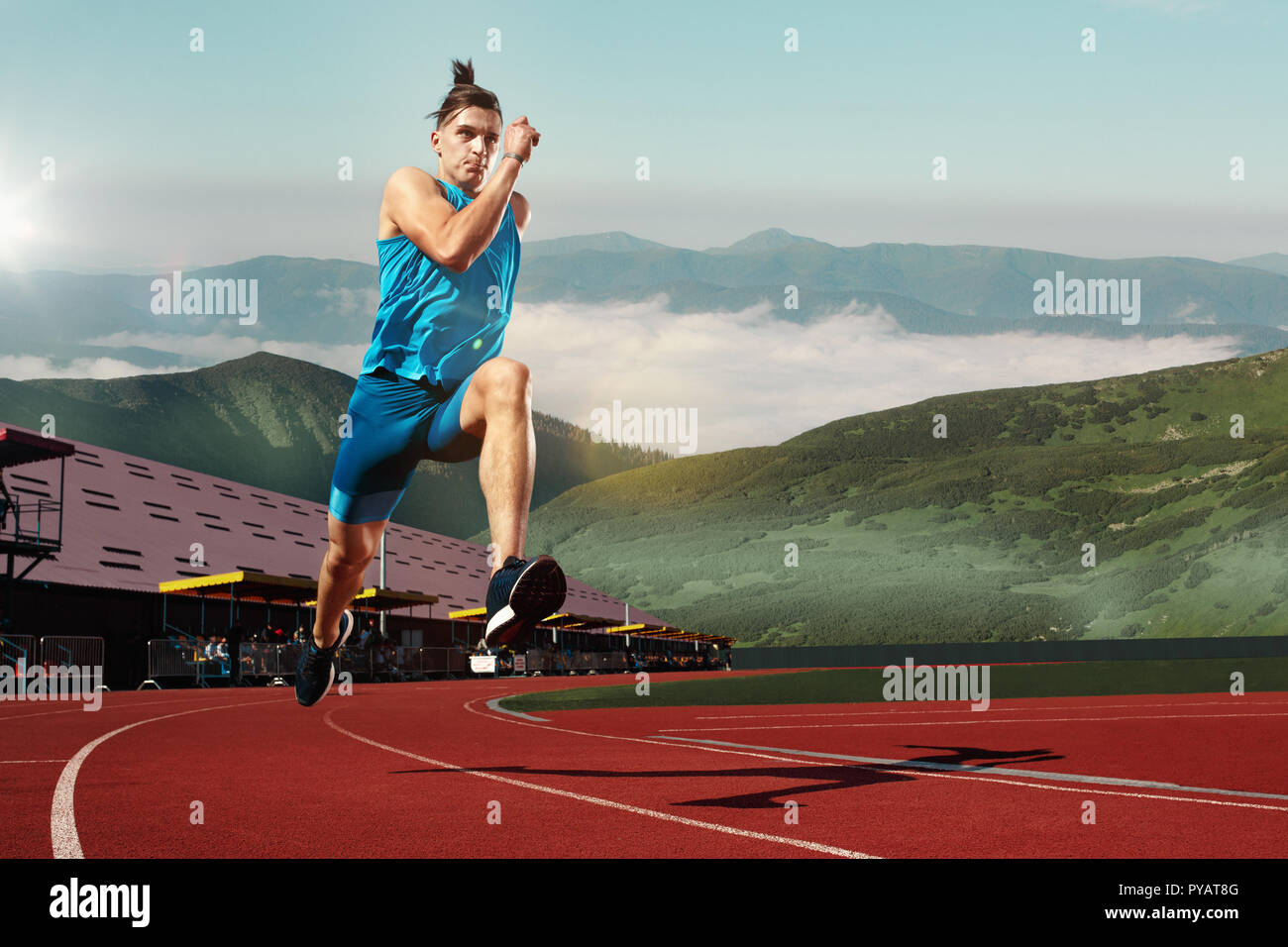 man running in the track. Fit male runner jogging during training at ...