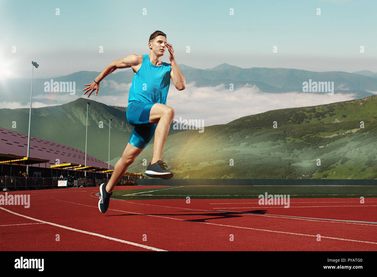 man running in the track. Fit male runner jogging during training at ...