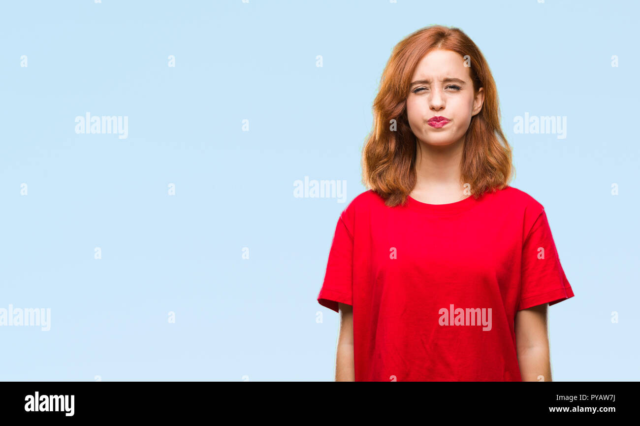 Young beautiful woman over isolated background puffing cheeks with ...