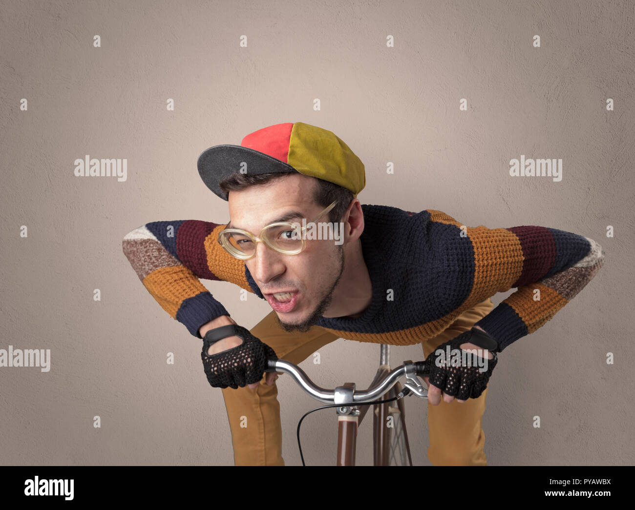 Nerd young foolish biker on a bike with oldschool outfit Stock Photo ...