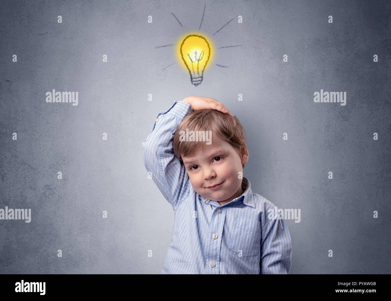 Adorable little kid mull over in front of a grey wall with idea symbol ...
