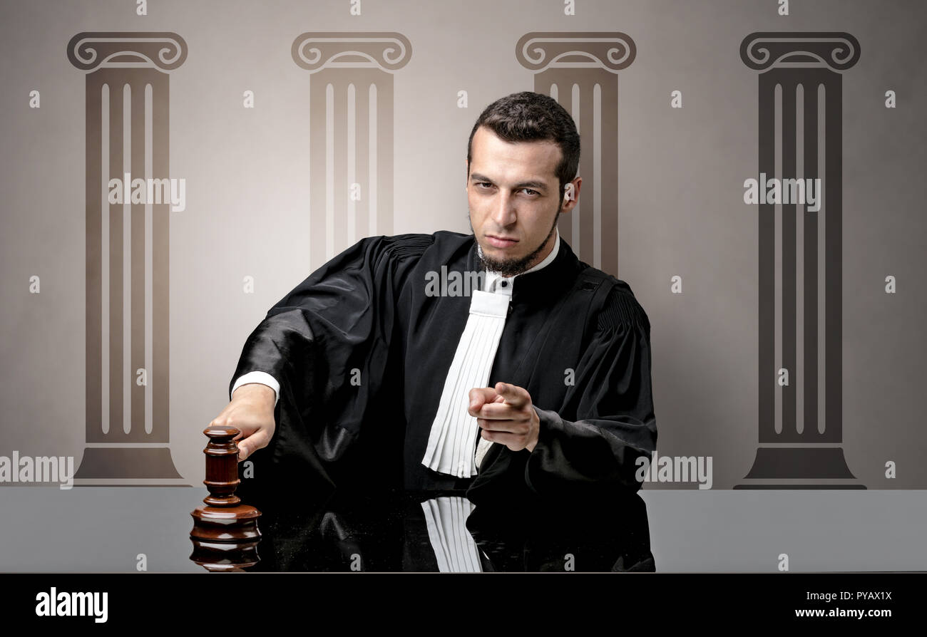 Young judge in front of a courthouse symbol making decision Stock Photo ...