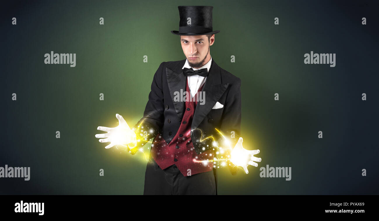 Magician holding his sparkling power between his two hand Stock Photo ...