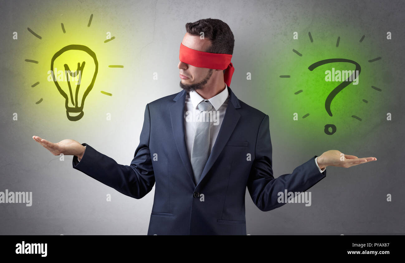 Covered eye businessman with bulb and question sign symbols around ...