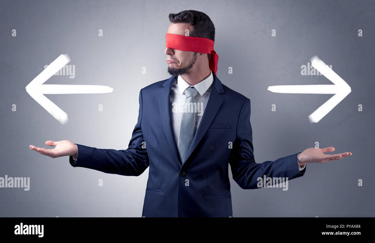 Covered eye businessman choosing between two directions Stock Photo - Alamy