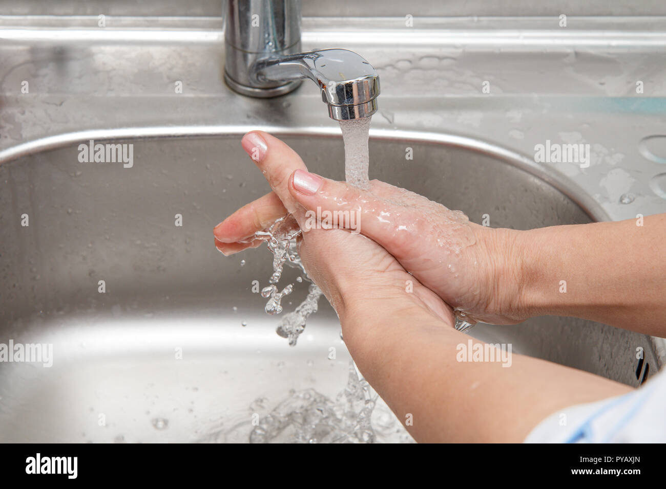Physician is washing his hands under tap water. Preparation for medical ...