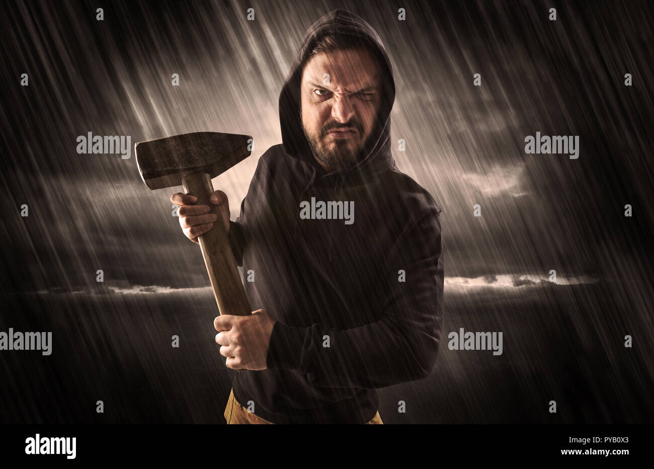Masked armed poacher in mysterious rainy coastal weather concept Stock ...