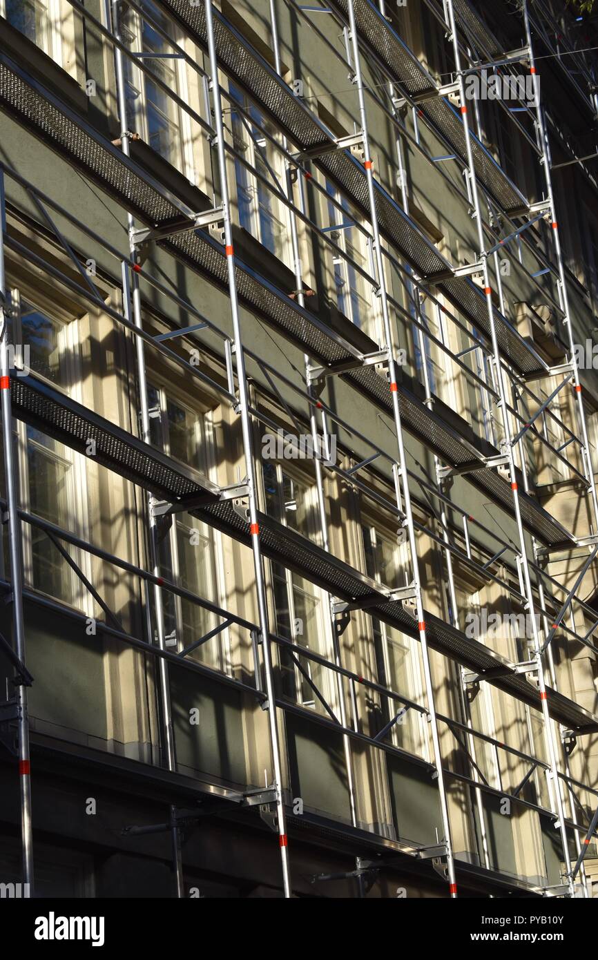 Scaffolding i front of apartment house, sunligth reflekting in windows ...