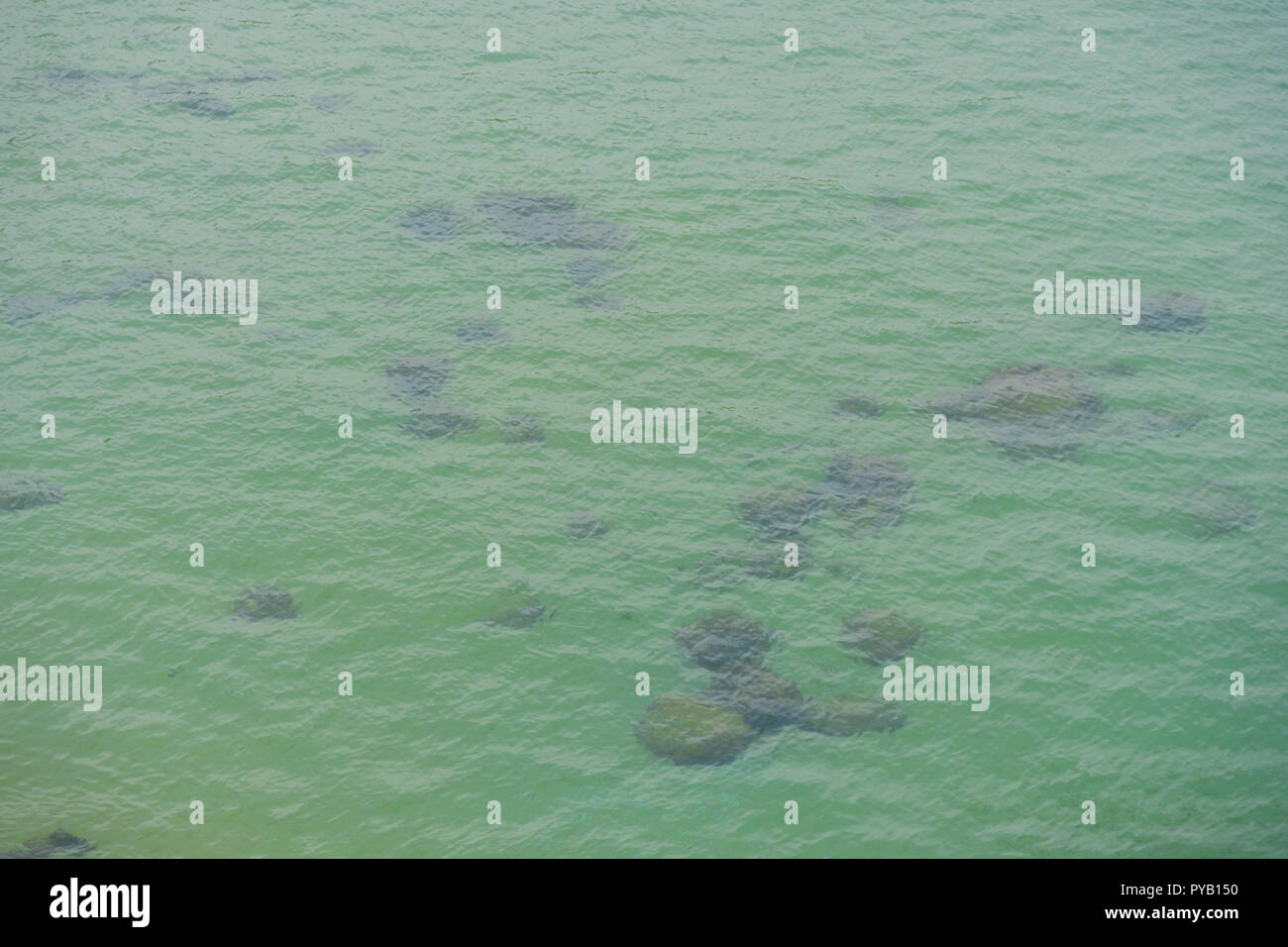 Surface of water in shallow water. Stones under the water Stock Photo ...