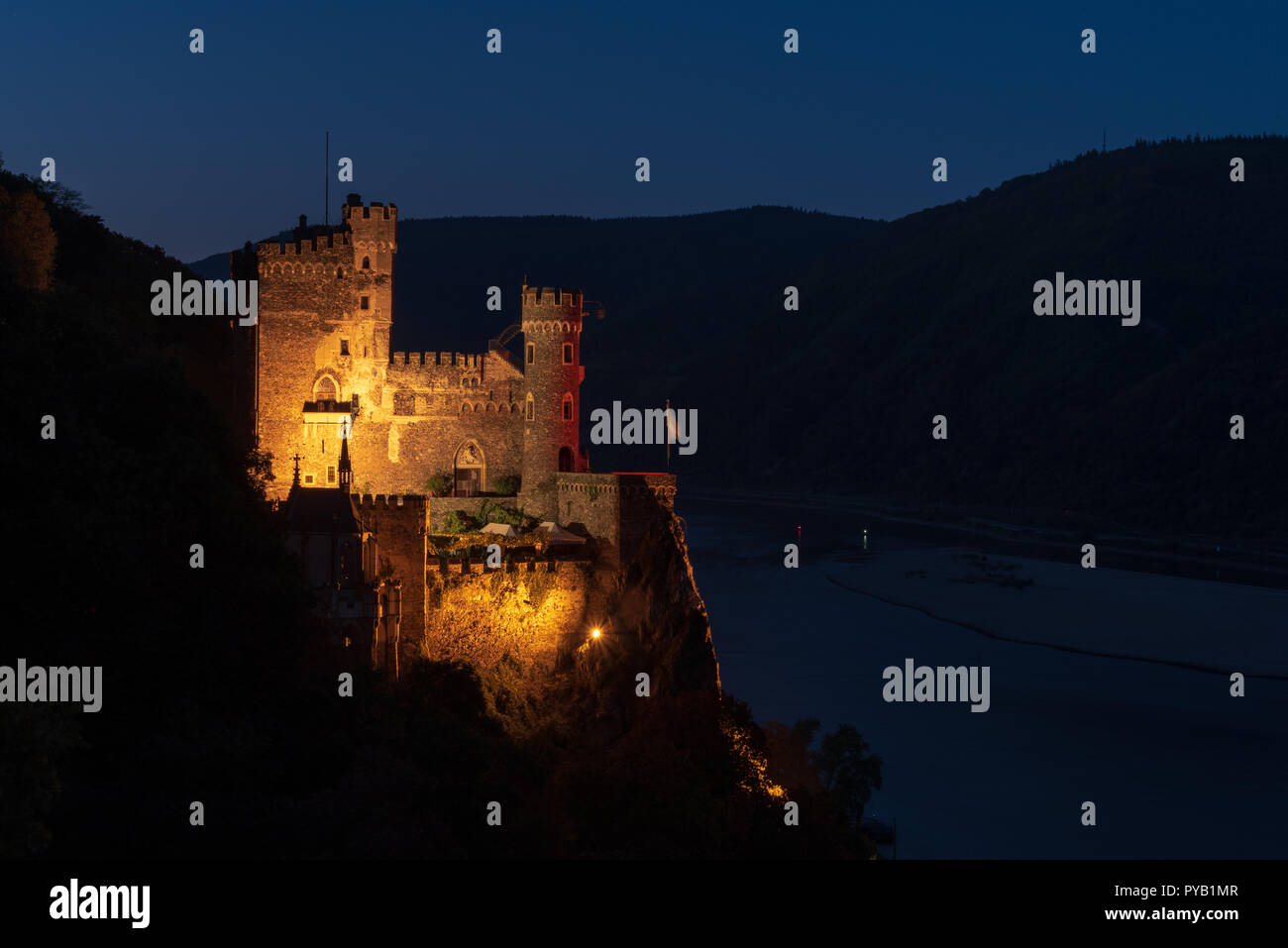 Rheinstein Castle illuminated at night Stock Photo - Alamy