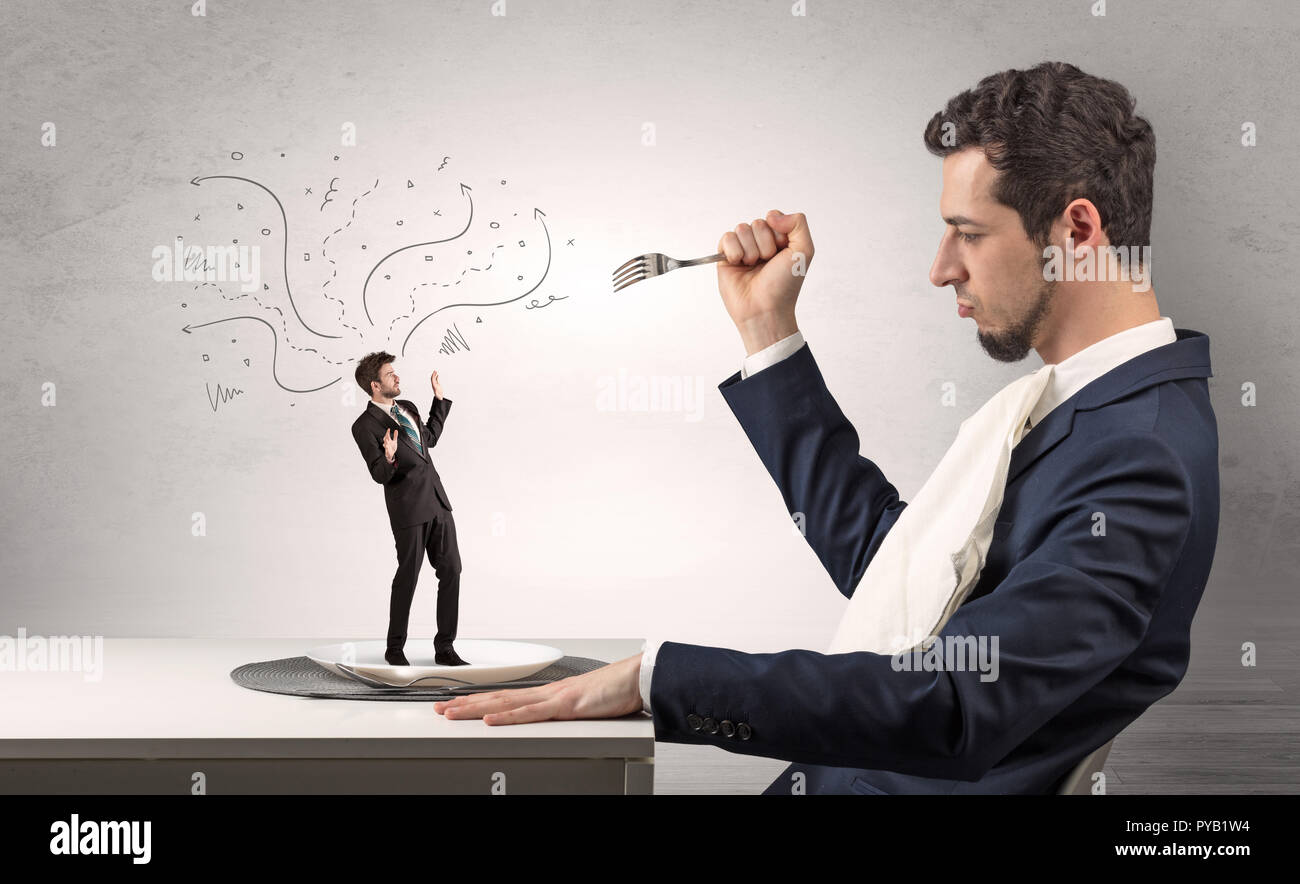 Big boss eating small businessman with knife and fork Stock Photo - Alamy