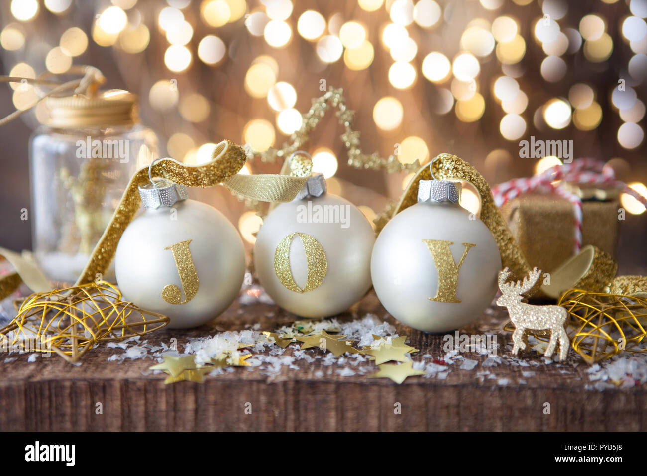 Festive decorations with Christmas baubles in front of cheerful lights ...