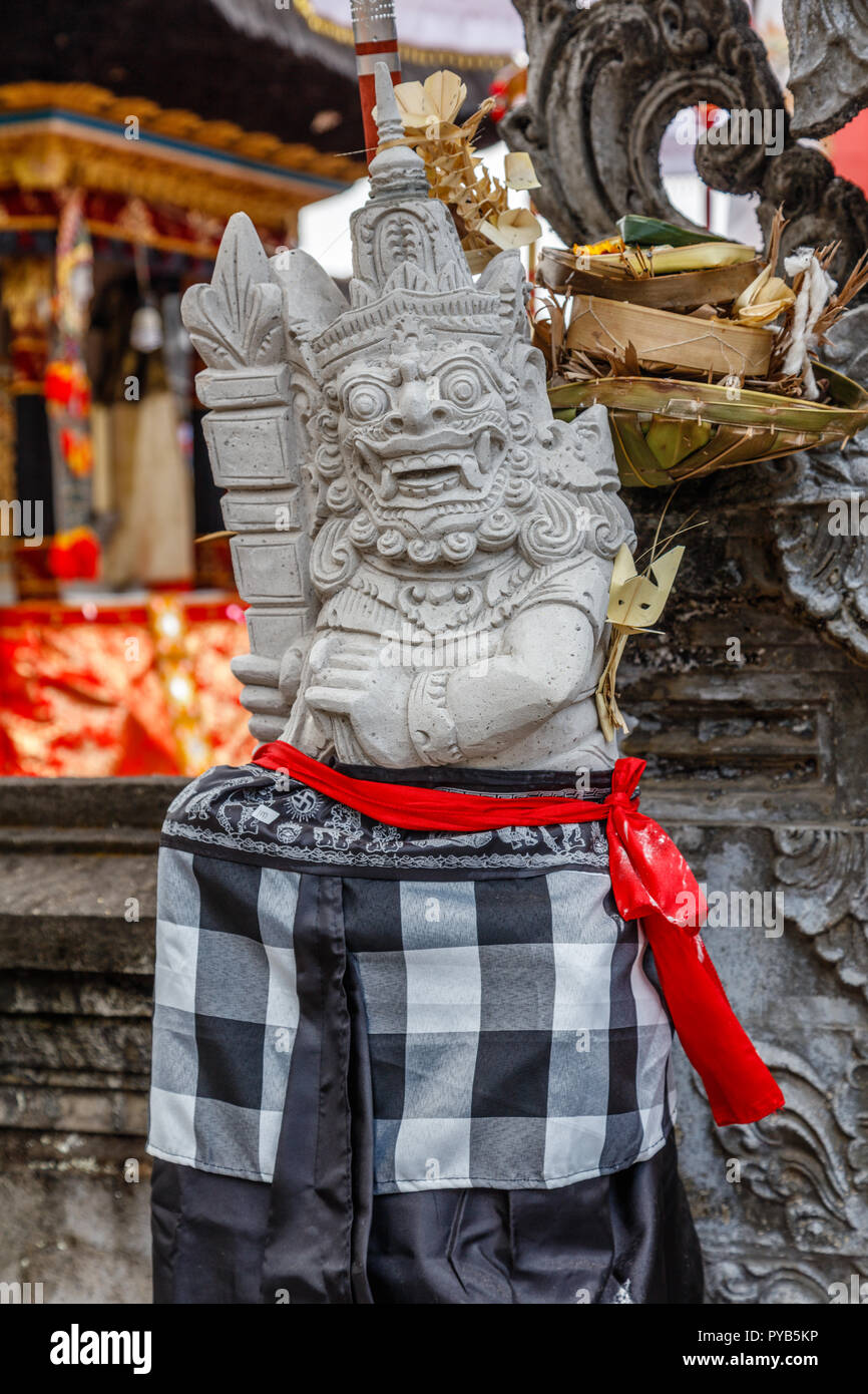Guard statue in checked sarong at Pura Kehen, Balinese Hindu temple in ...