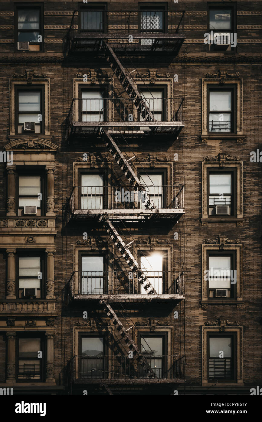Facade of a typical New York block of flats with fire escape at the ...