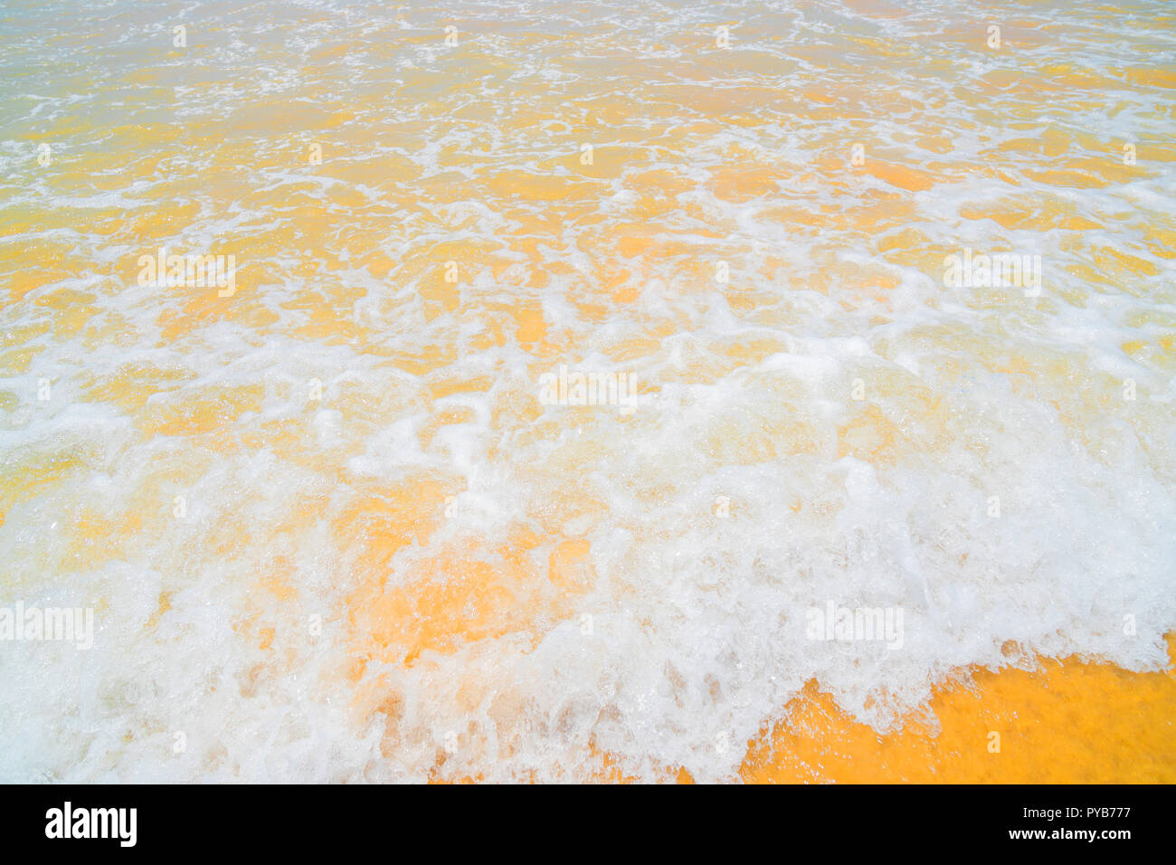 On the yellow sand is an ocean wave Stock Photo - Alamy