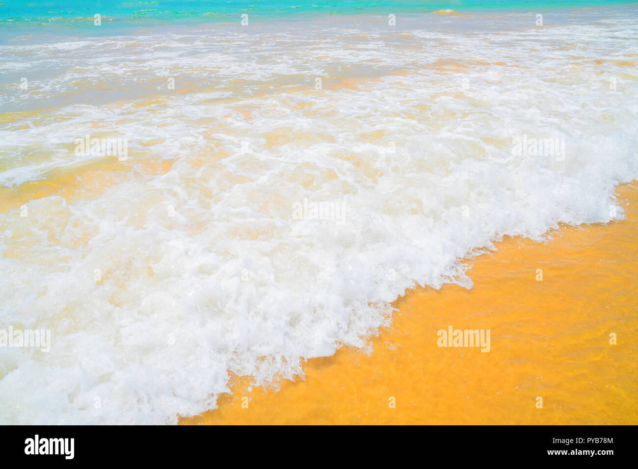 On the yellow sand is an ocean wave Stock Photo - Alamy