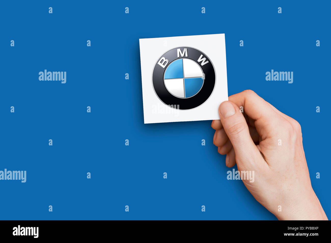 LONDON, UK - October 26th 2018: Hand holding a BMW logo. BMW is an ...