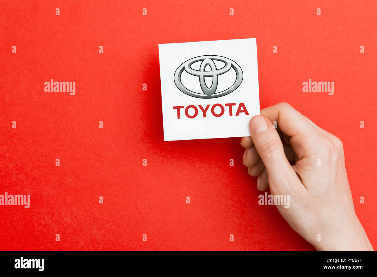 LONDON, UK - October 26th 2018: Hand holding a Toyota logo. Toyota is ...