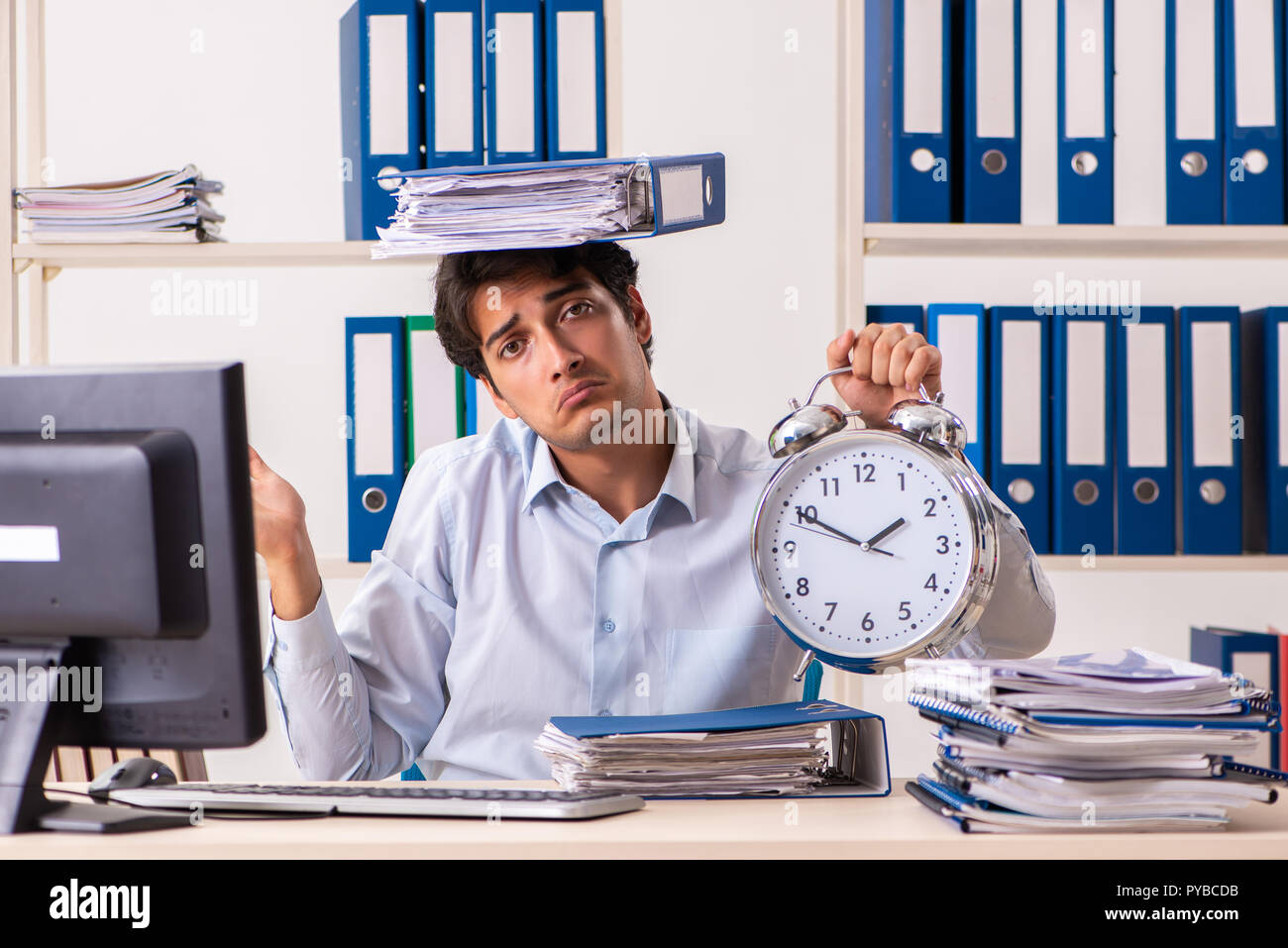 Overloaded busy employee with too much work and paperwork Stock Photo ...
