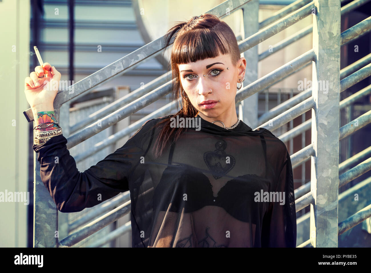 young female singer rap caucasian tattooed posing in front of a ...