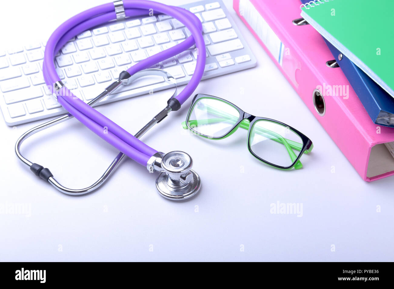 Medical record concept with stethoscope over pile of folders. Keyboard ...