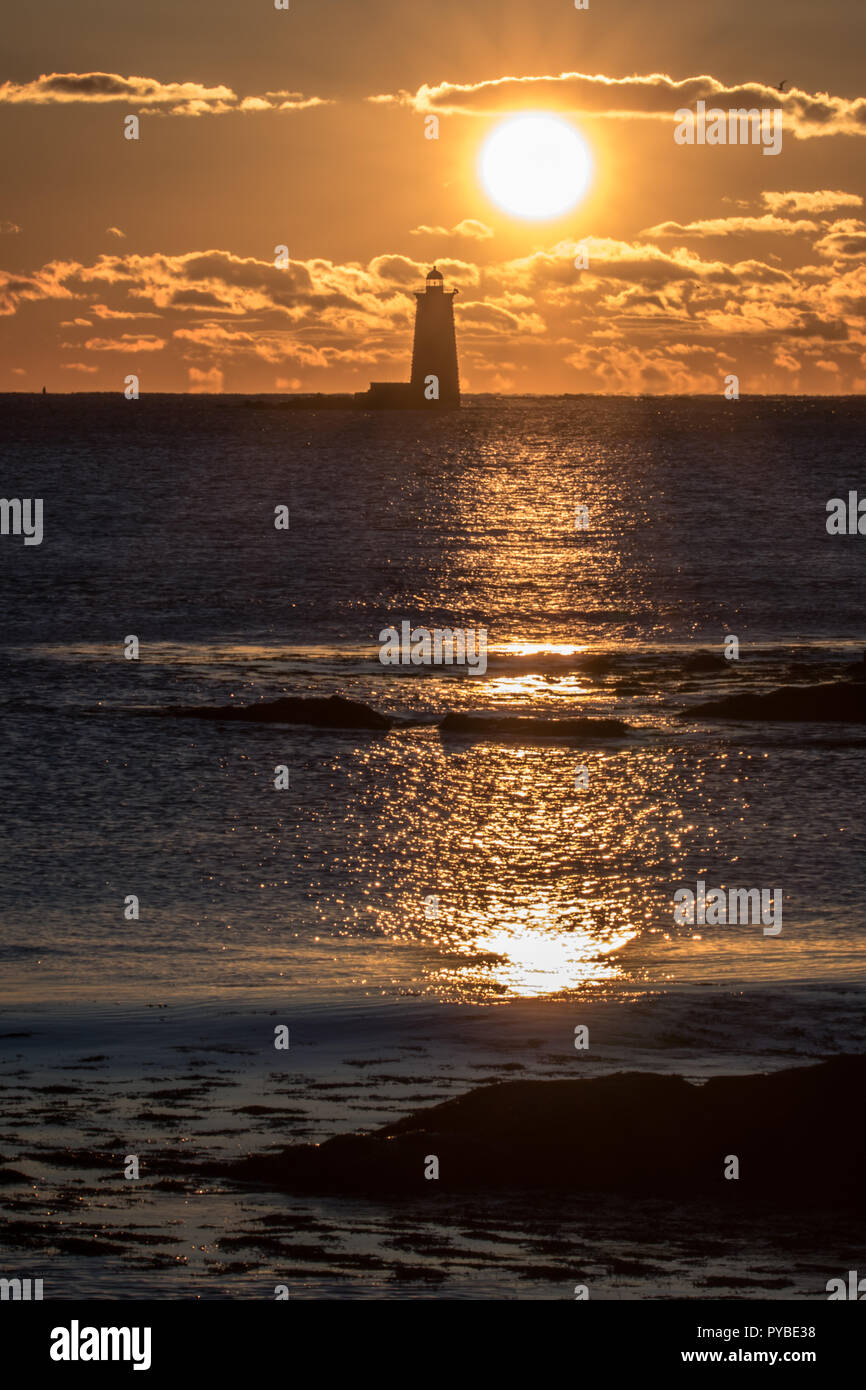 lighthouse with sun setting Stock Photo - Alamy