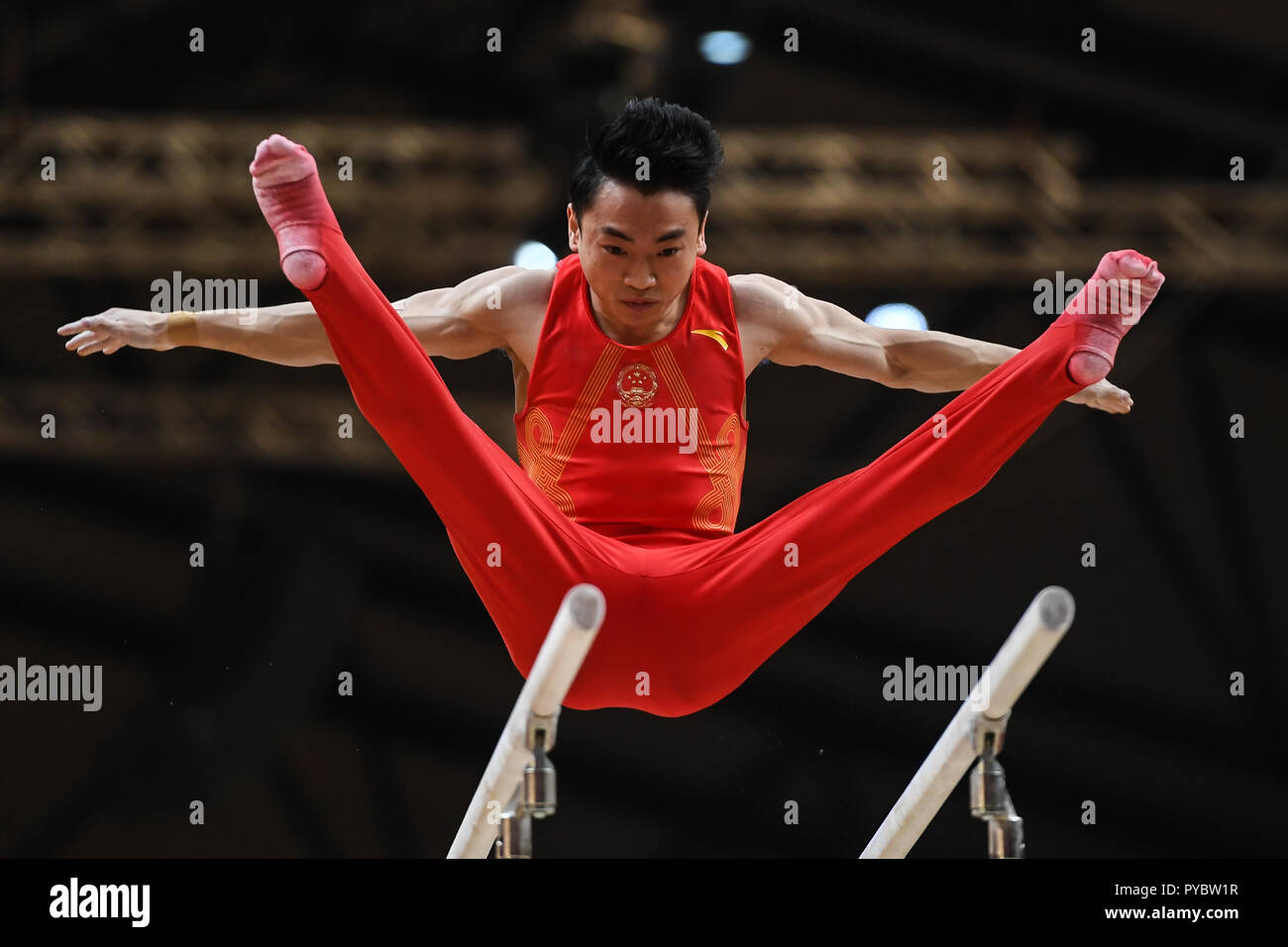 Doha, Qatar. 26th Oct, 2018. ZOU JINGYUAN competes on the parallel bars ...